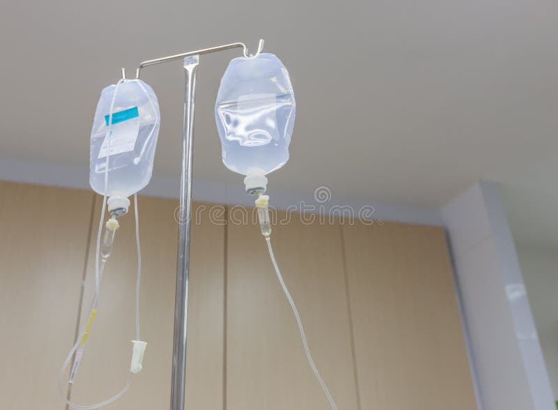 IV Dripping, Bag and Tube of Saline Solution at an IV Stand. Stock ...