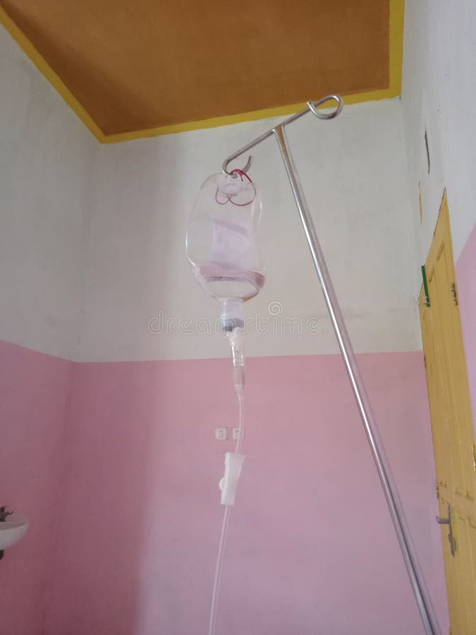 IV Fluid Bottles Hanging on IV Poles in the Treatment Room Stock Photo ...