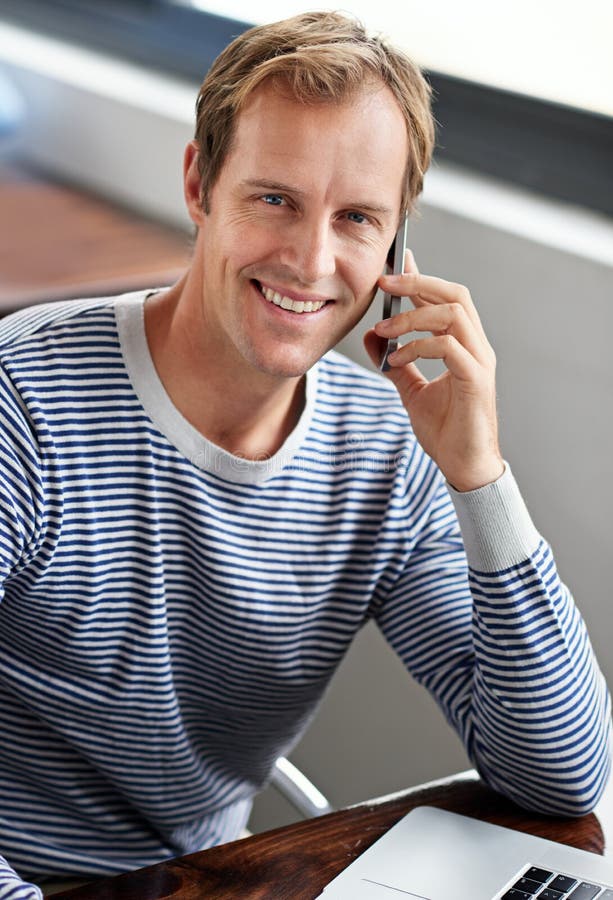 Ive Got Everything Under Control. a Man Talking on His Cellphone in a ...