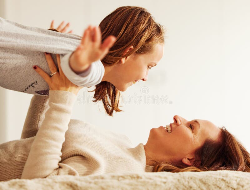 Ive Got You Dont Worry An Attractive Young Mother Lying On The Bed At