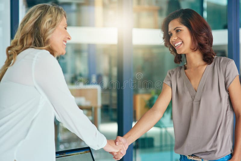 Ive Heard so Many Good Things...two Businesspeople Shaking Hands in an ...
