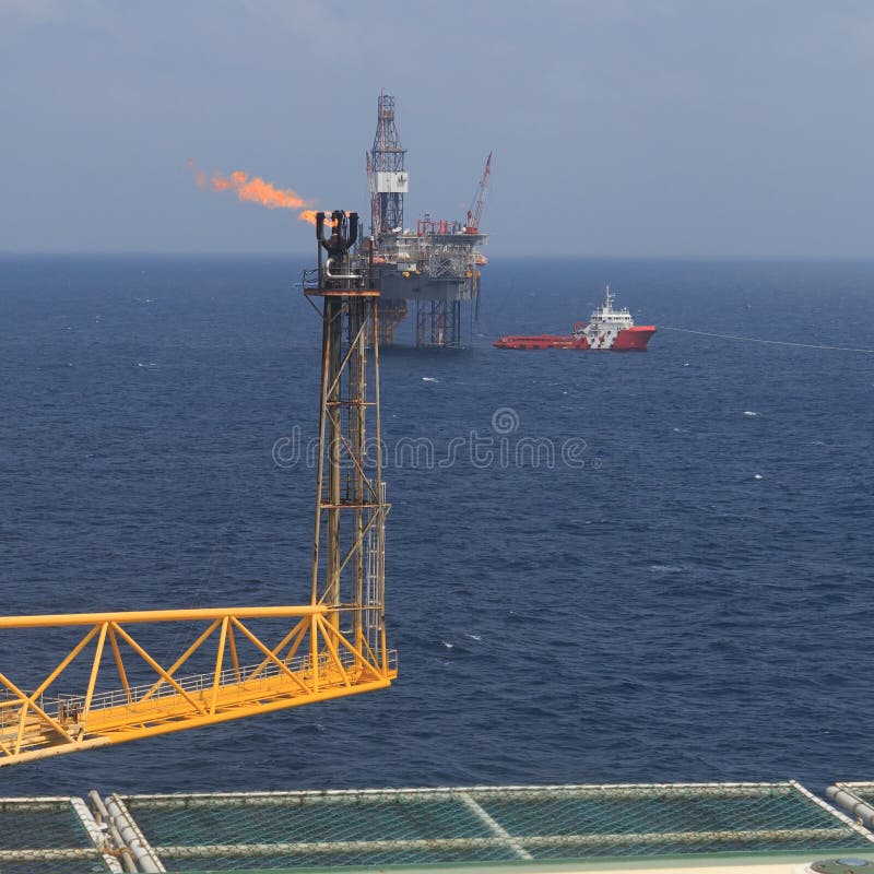 Jack Up Drilling Rig, Flare Boom, and Crew Boat Stock Image - Image of ...