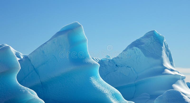 Jagged Ice Structures Under a Clear Blue Sky, Showcasing a Striking ...