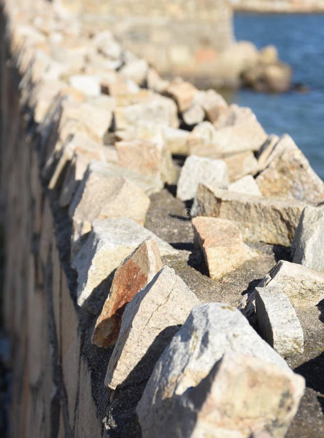 Coastal Retaining Wall with Sharp Jagged Rocks Stock Photo - Image of ...