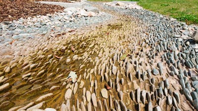 Jagged rocks on riverbed stock photo. Image of natural - 122990734