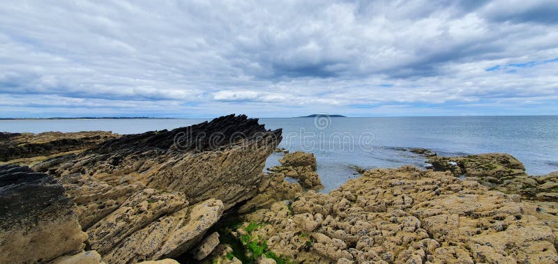 Jagged rocks by the sea stock photo. Image of terrain - 269884482