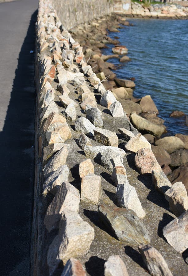 Coastal Retaining Wall with Sharp Jagged Rocks Stock Photo - Image of ...