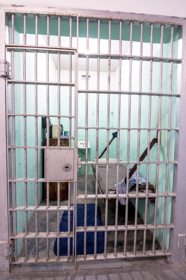 Jail cell through the bars stock image. Image of prison - 30523653