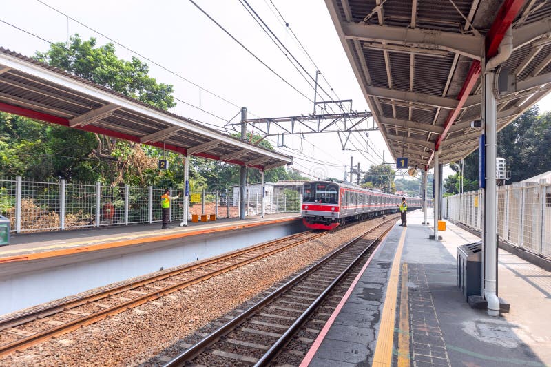 A Commuter Train Arrives at the Station and Two Security Guards are on ...