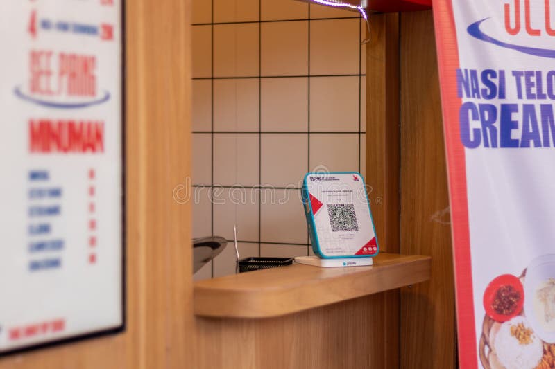 A QR Code or QRIS Payment Machine at a Food Stall. Payment Method in Indonesia for Mobile ...