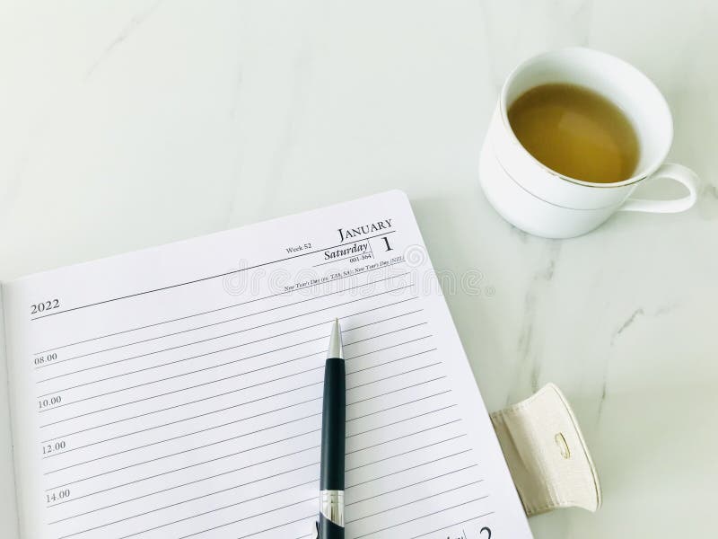 January 1st and a Pen, First Page of 2022 Diary with Clasp, and a Cup ...