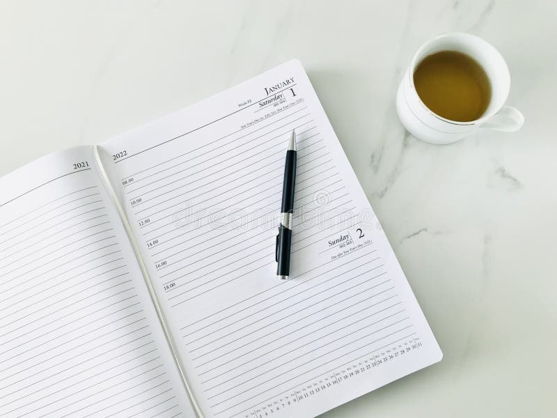 January 1st, First Page of 2022 Diary and a Small White Flower on White ...