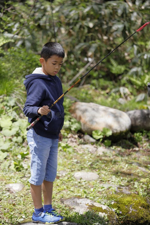 Japanese boy catching fish stock image. Image of people - 147660411