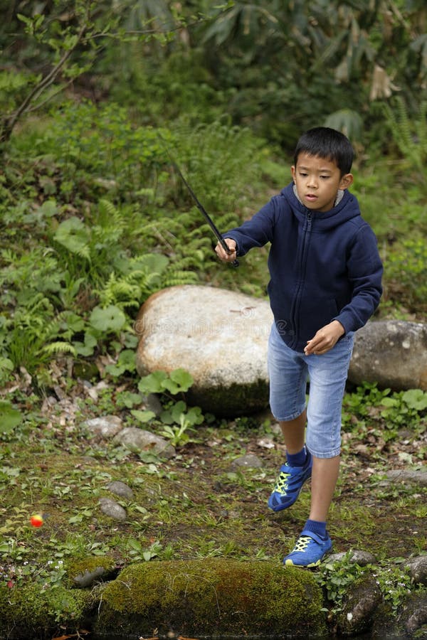 Japanese boy catching fish stock photo. Image of fishing - 150268316