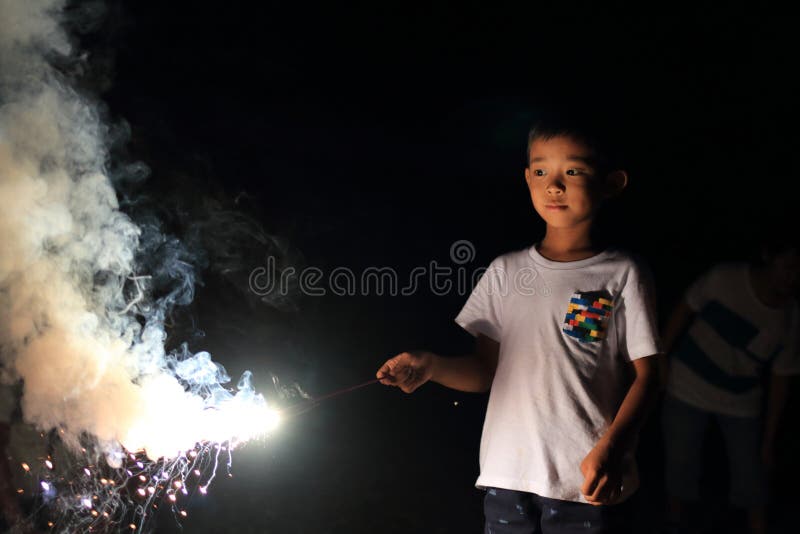 Japanese Boy Doing Handheld Fireworks Stock Image - Image of dark ...
