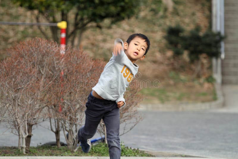 Japanese boy playing catch stock image. Image of smiling - 68075851
