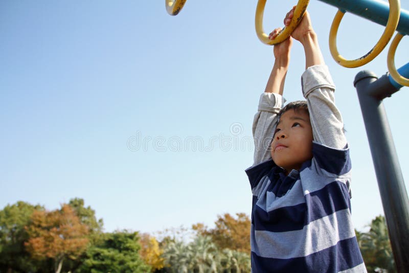 Japanese Boy Playing with a Monkey Bars Stock Photo - Image of blue ...