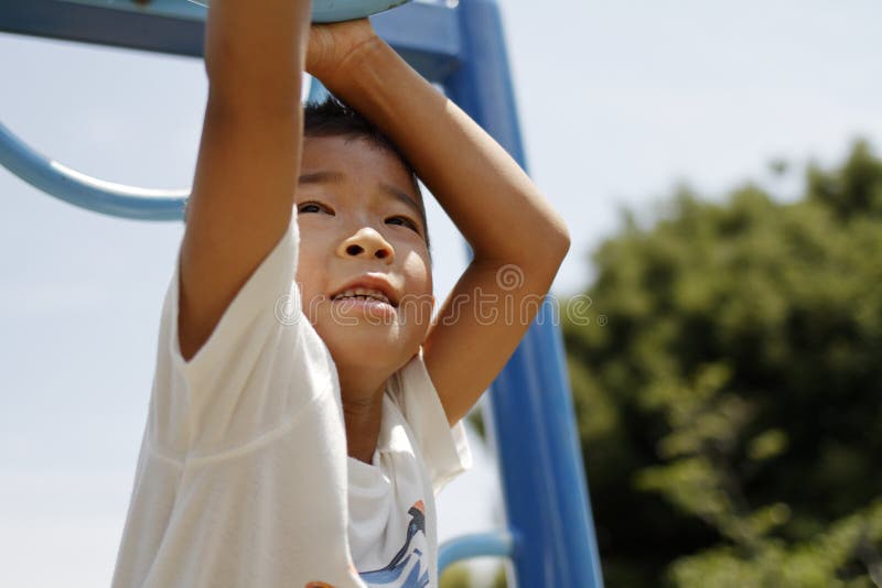 Japanese Boy Playing with a Monkey Bars Stock Image - Image of blue ...