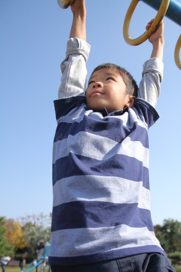 Japanese Boy Playing with a Monkey Bars Stock Photo - Image of male ...