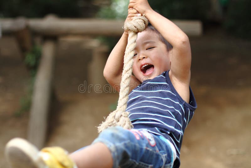 Japanese Boy Playing with Tarzan Rope Stock Photo - Image of people ...