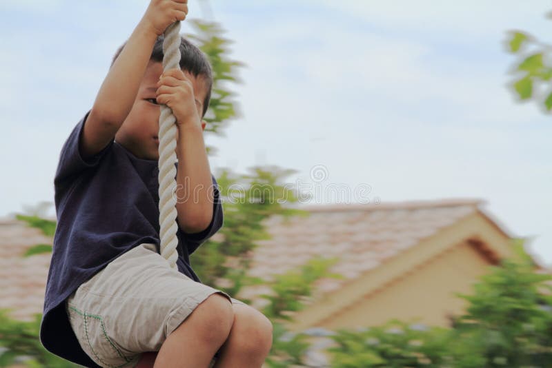 Japanese Boy Playing with Tarzan Rope Stock Photo - Image of rope ...