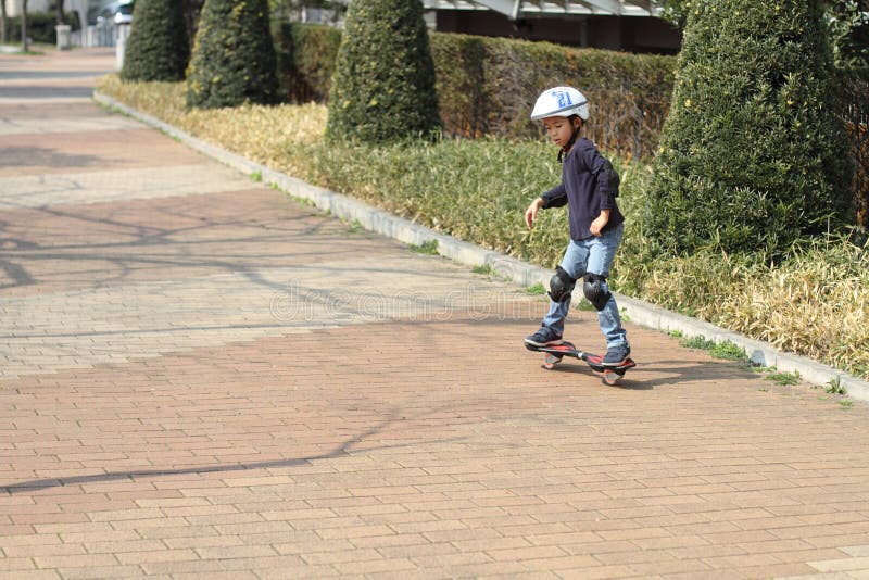 Japanese Boy Riding on a Casterboard Stock Photo - Image of seven, male ...