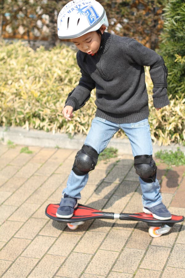 Japanese Boy Riding on a Casterboard Stock Photo - Image of smile ...