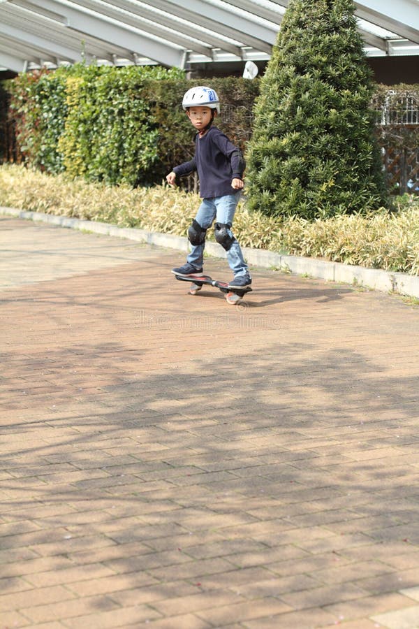 Japanese Boy Riding on a Casterboard Stock Image - Image of human, ride ...