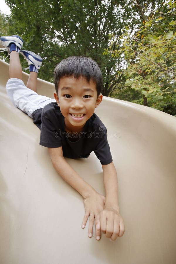 Japanese boy on the slide stock photo. Image of athletic - 133159132