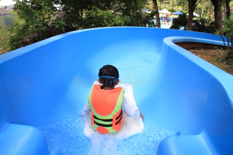 Japanese Boy on the Water Slide Stock Image - Image of water, swimming ...