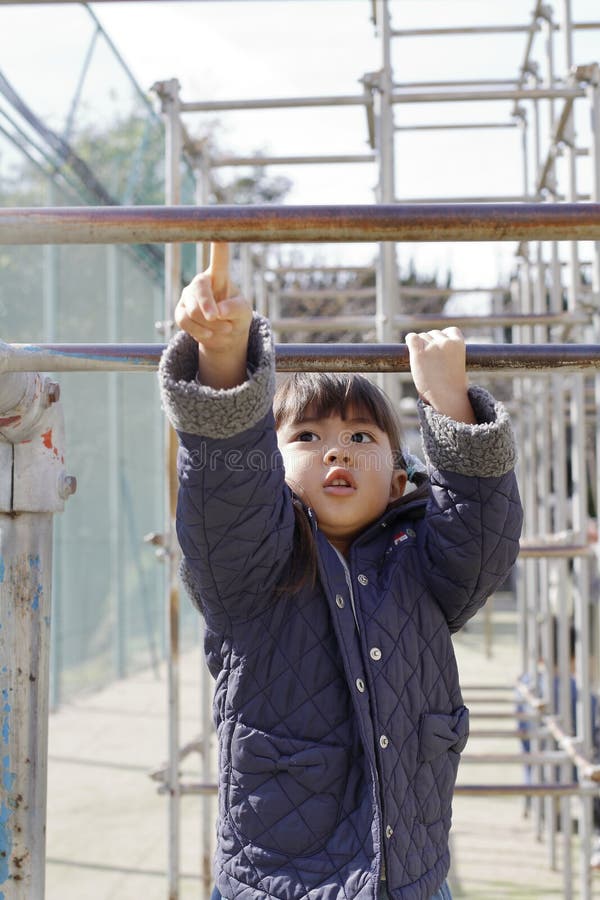 Japanese Girl Playing with a Monkey Bars Stock Photo - Image of aerial ...
