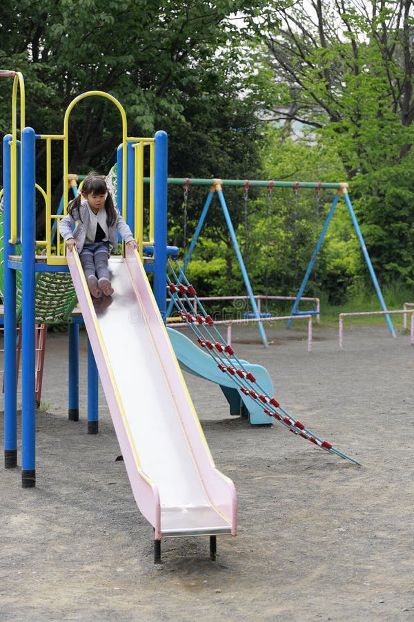Japanese girl on the slide stock photo. Image of blue - 182317588