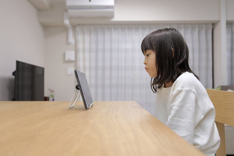 Japanese Girl Watching Video on Tablet PC Stock Photo - Image of human ...