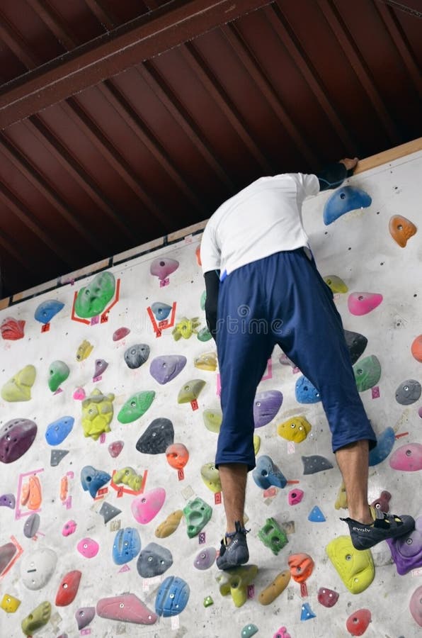 A Japanese Man Climbing a Rock Wall Indoor. Stock Photo - Image of ...