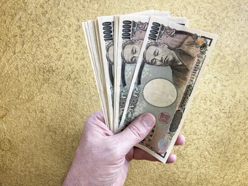 Japanese money in man hand stock image. Image of finance - 326769643