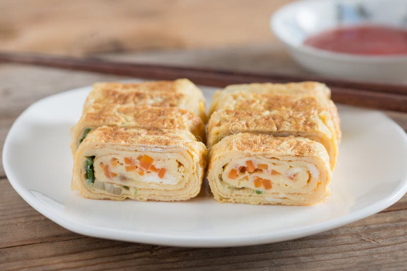 Japanese Snack - Eggs Roll with Carrot and Onion on White Plate. Stock ...