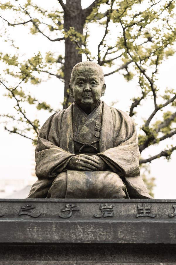 Japanese Statue in a Grassy Field Surrounded by Trees Stock Photo ...