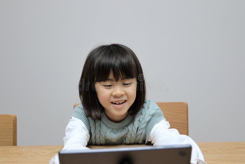 Japanese Student Girl Watching Video on Tablet PC Stock Photo - Image ...