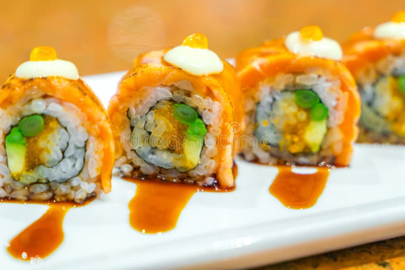 Japanese Sushi Rolls with Fresh Raw Salmon on White Plate . Stock Photo ...