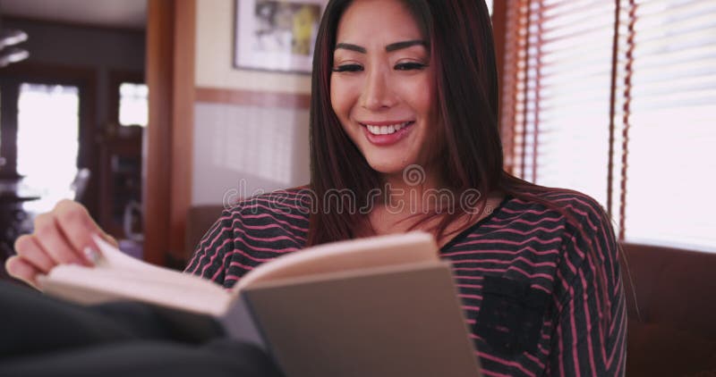 Japanese Woman Reading a Book on Couch Stock Video - Video of ...