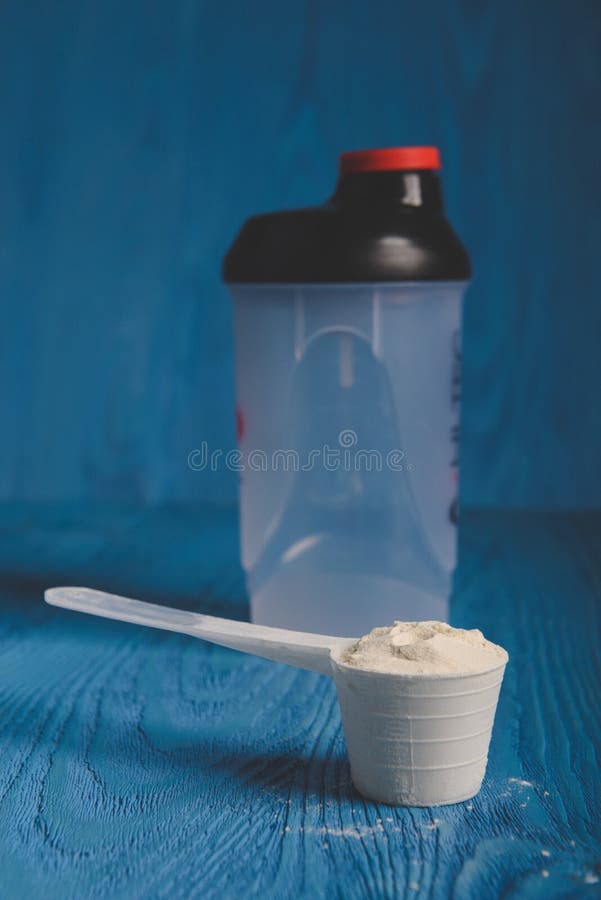 Jar and Bottle Preparing Protein Shake on Blue Table Stock Photo ...