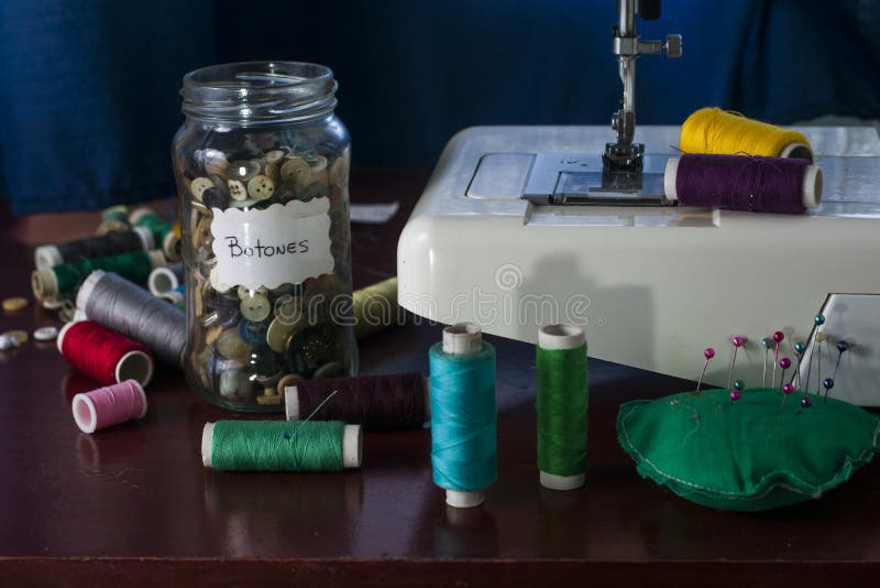 A Jar of Buttons with Some Threads and a Sewing Machine Stock Image ...