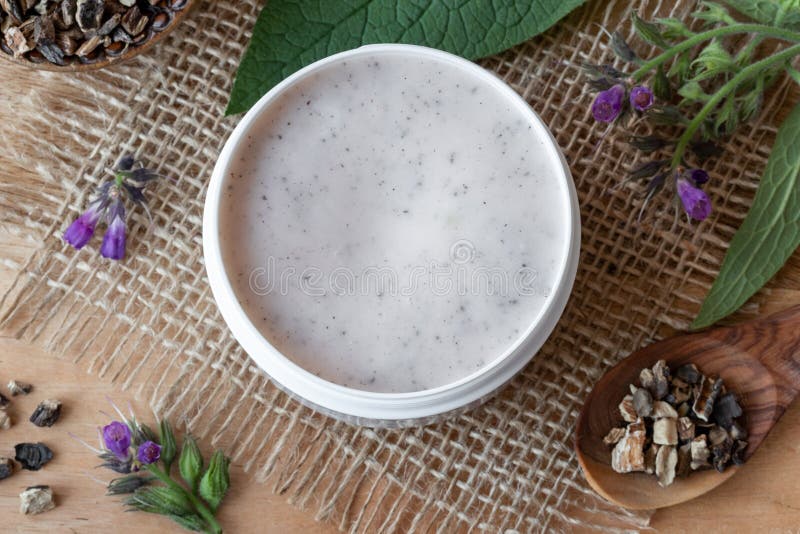 A Jar of Homemade Comfrey Root Ointment with Blooming Comfrey Pl Stock ...
