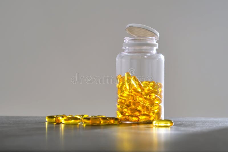 A Jar of OMEGA 3 Capsules Stands on a Dark Table. Stock Image - Image ...