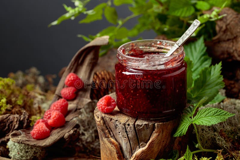 A Jar of Raspberry Jam with Fresh Berries on an Old Tree Trunk in the ...