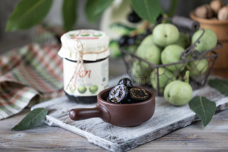 Jar of Walnut Jam on a Wooden Table and a Group of Green Walnuts Stock ...