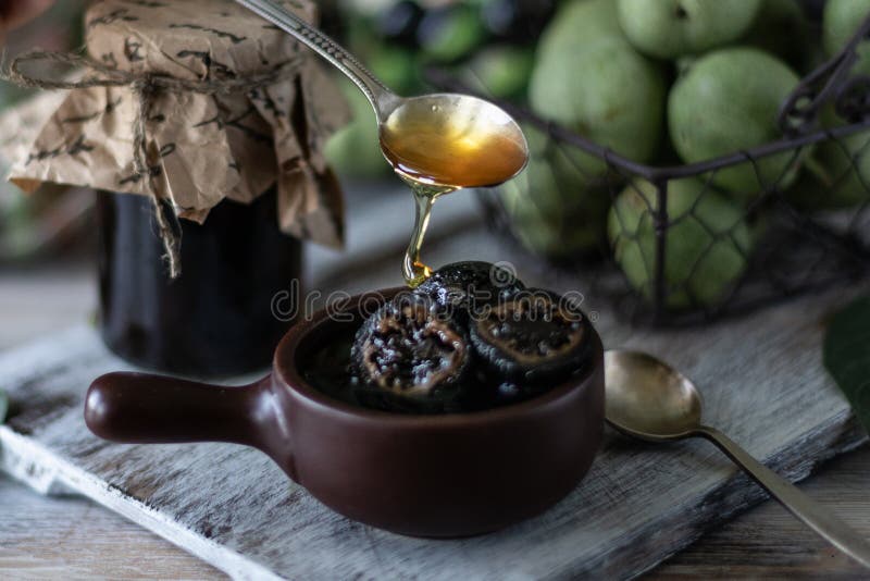 Jar of Walnut Jam on a Wooden Table and a Group of Green Walnuts Stock ...