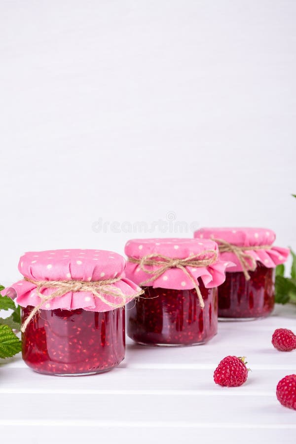 Jars with Raspberry Jam Placed in Rows and Fresh Raspberry on Wooden ...