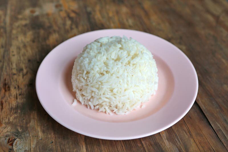 Jasmine Rice in Pink Plate on Wooden Table Stock Image - Image of ...