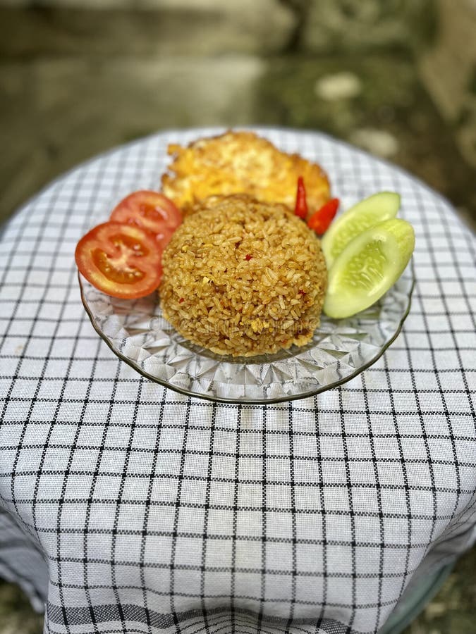 Javanese Fried Rice Served on a Plate with Eggs and Vegetables. Stock ...